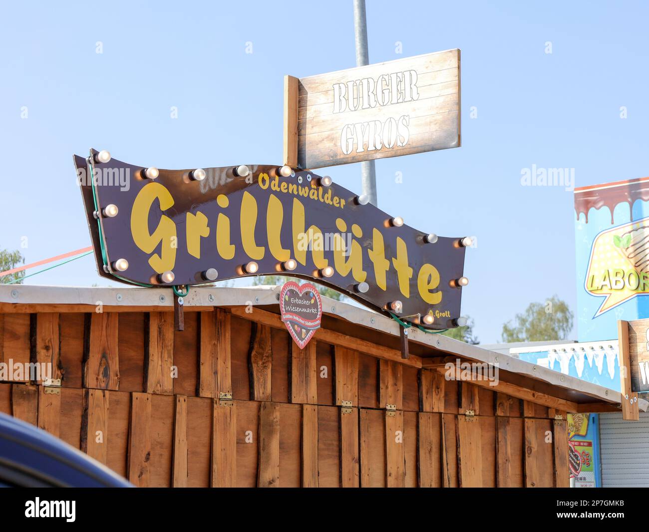 colorful booths and fun rides at a fairground Stock Photo - Alamy