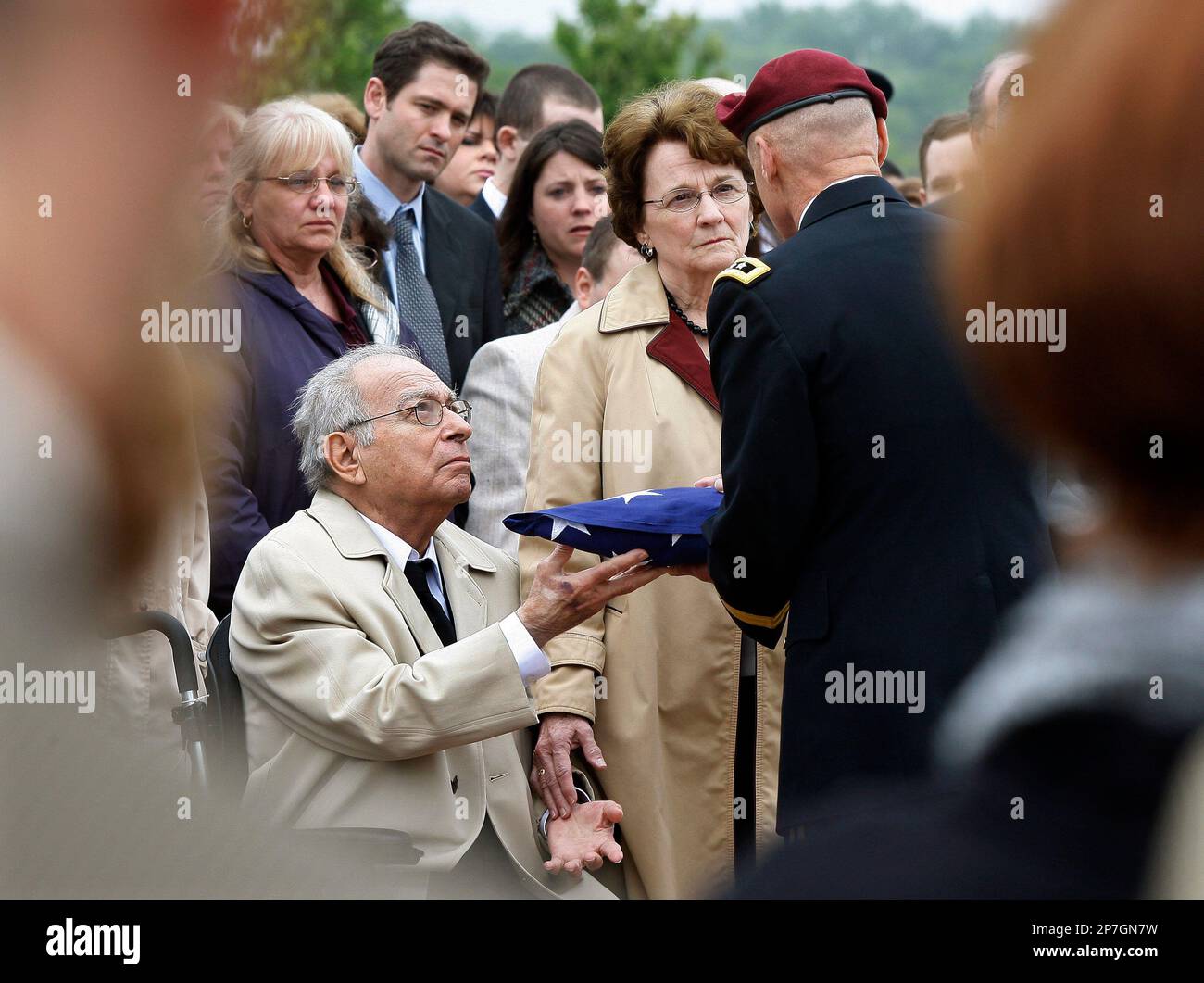U.S. Army Lt. Gen. Frank Helmick presents the American flag from the ...