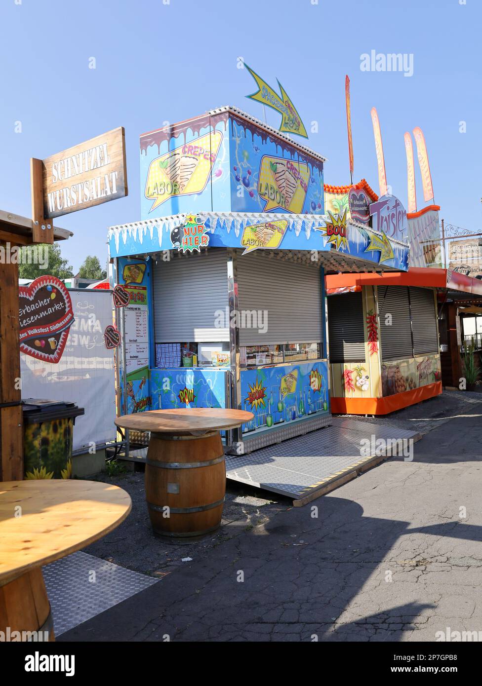 colorful booths and fun rides at a fairground Stock Photo - Alamy