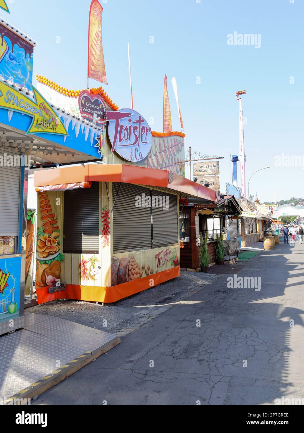 colorful booths and fun rides at a fairground Stock Photo - Alamy