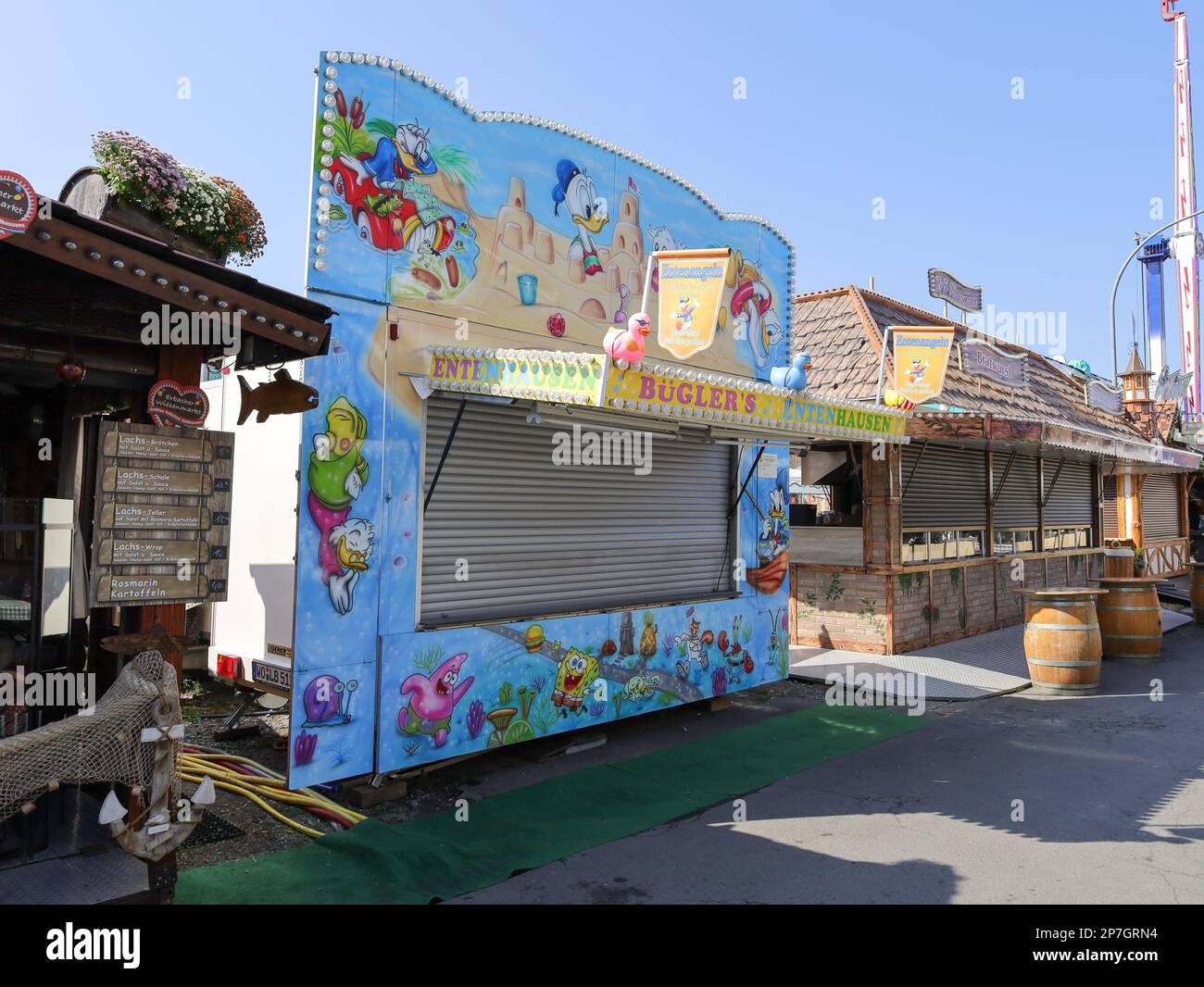 colorful booths and fun rides at a fairground Stock Photo - Alamy