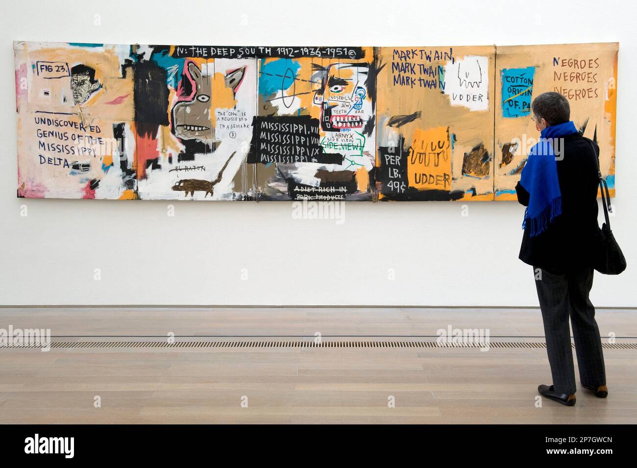 A visitor admires the artwork of Jean-Michel Basquiat titled ...