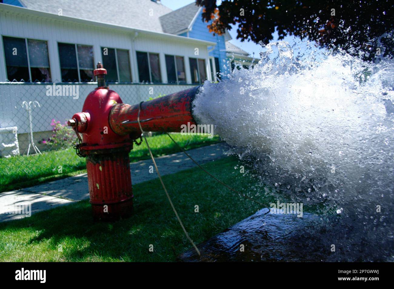 Water pours out of a fire hydrant at the corner of Jane Street and ...