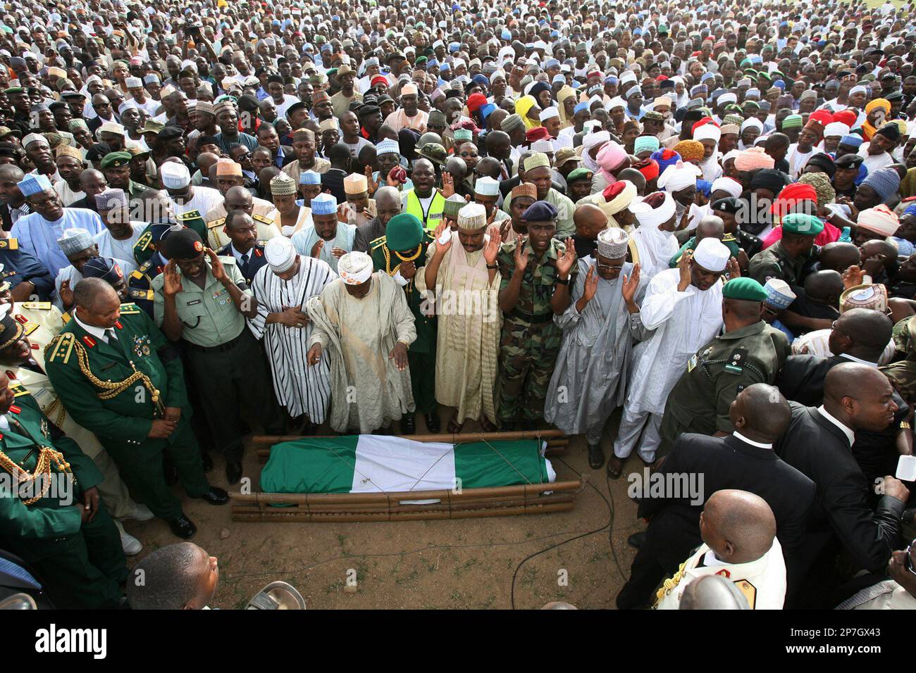 Mourners perform Muslim prayers around the body of late Nigerian ...