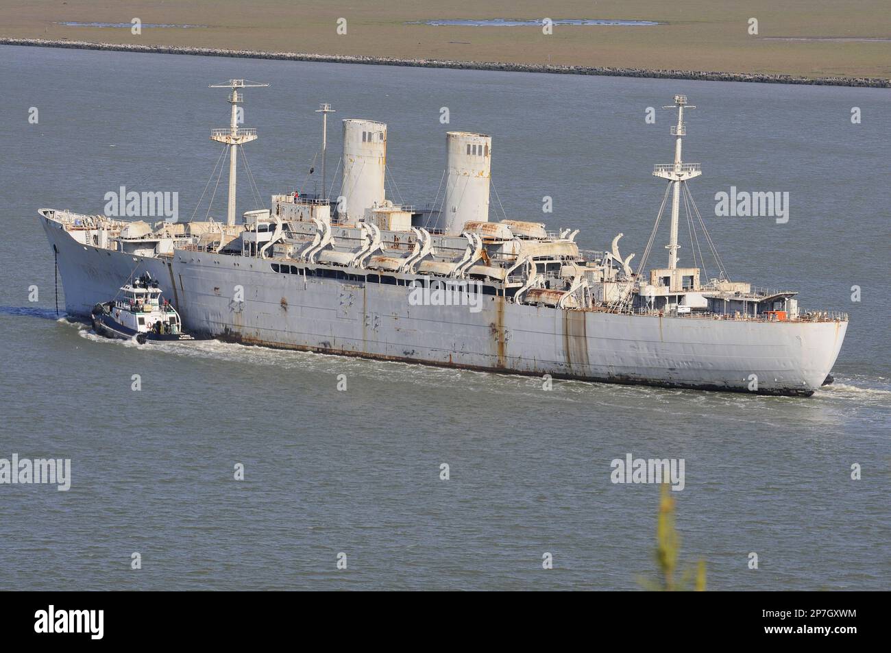 Tug boats guide the USS General John Pope into the San Pablo Bay north ...