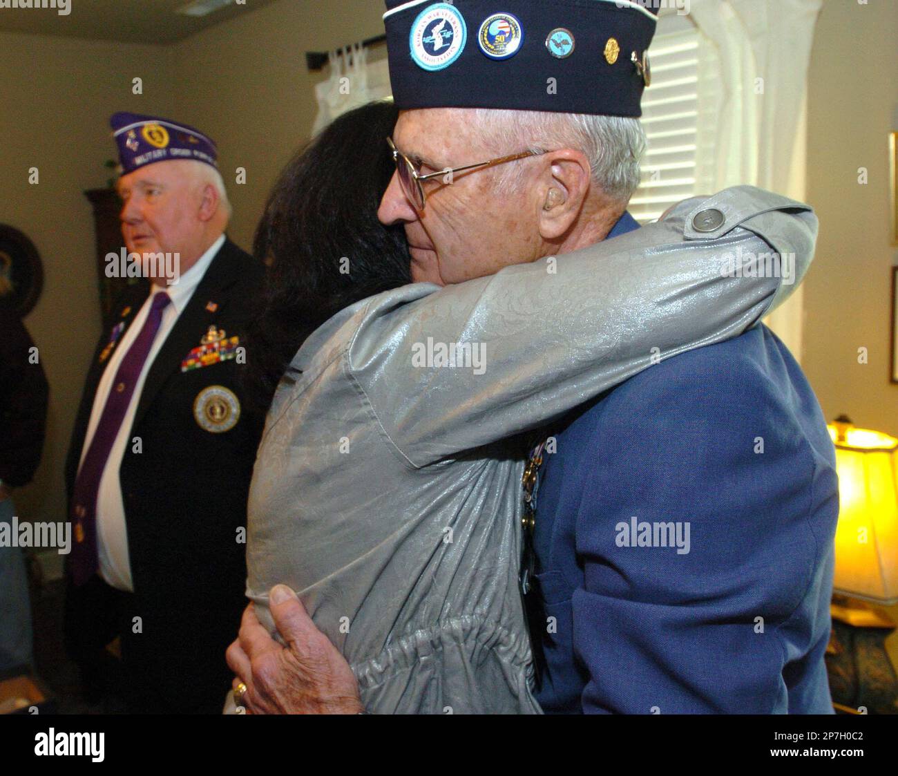 Judy Krause-Mobley gives a big hug to Grayson Tate after he read a ...
