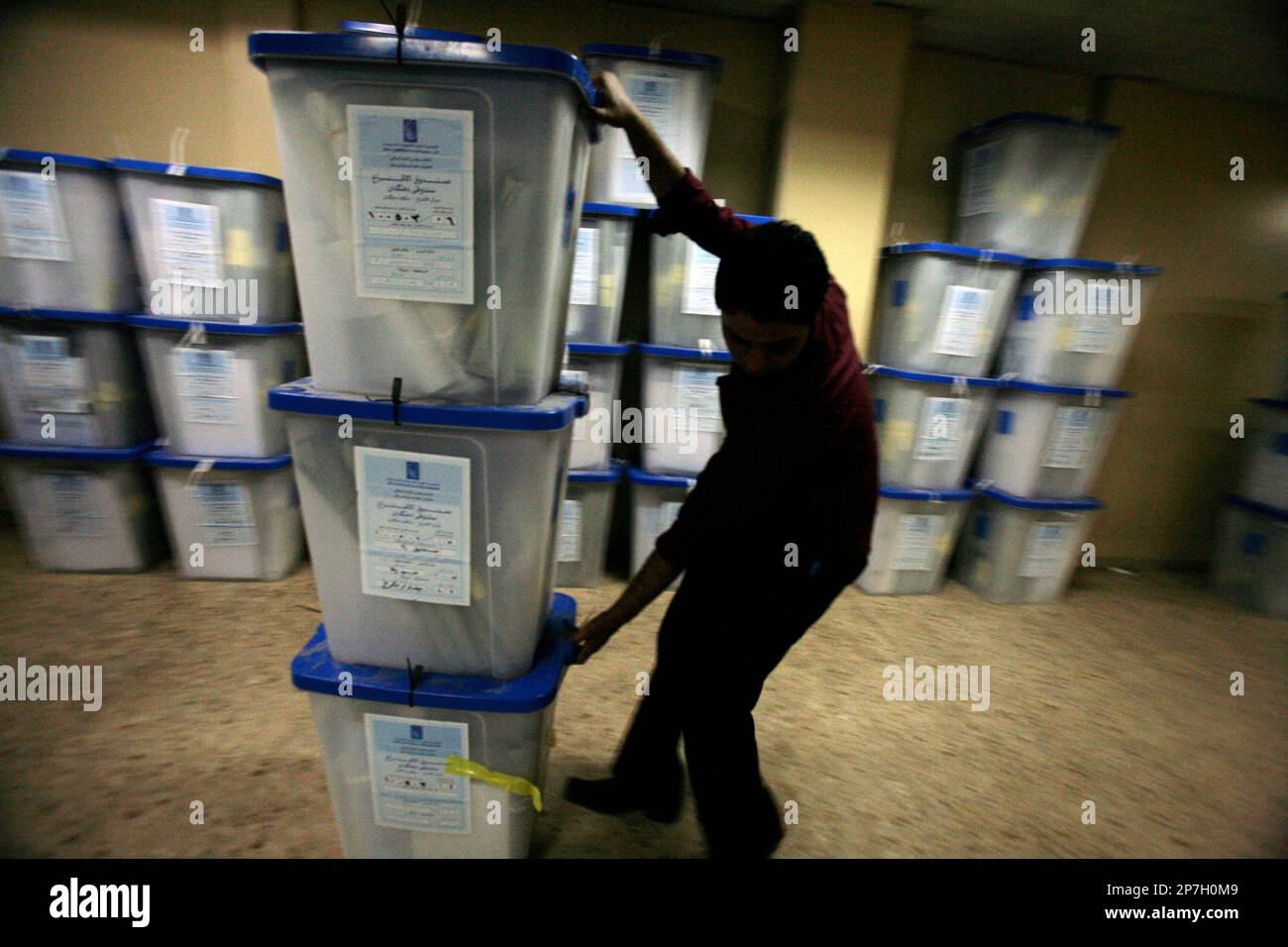 An electoral worker moves ballot boxes as votes in the March 7 national ...