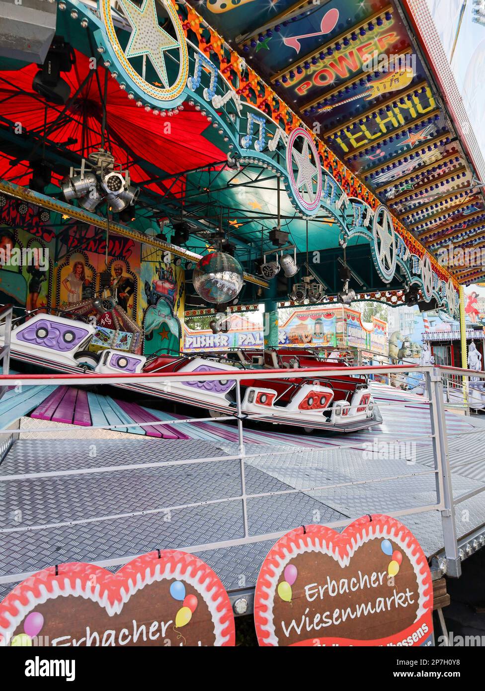 colorful booths and fun rides at a fairground Stock Photo - Alamy