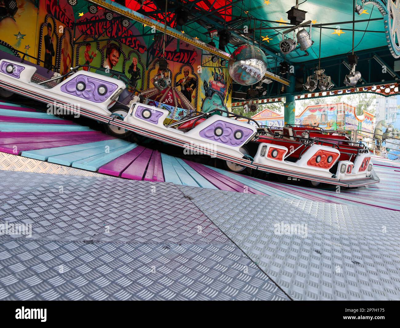 colorful booths and fun rides at a fairground Stock Photo - Alamy