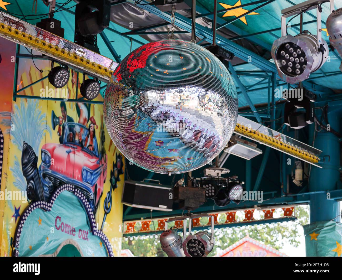 colorful booths and fun rides at a fairground Stock Photo - Alamy