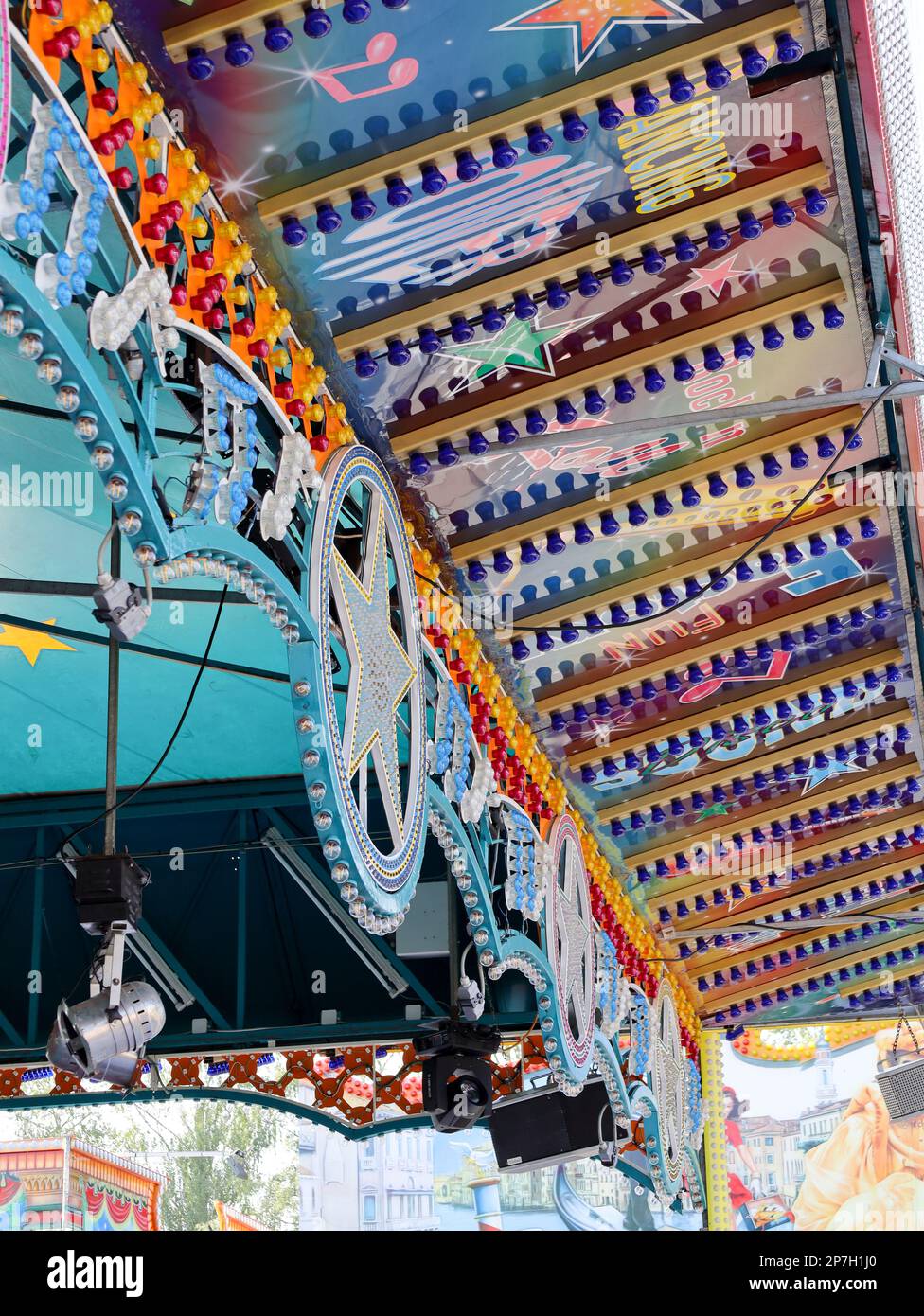 colorful booths and fun rides at a fairground Stock Photo - Alamy