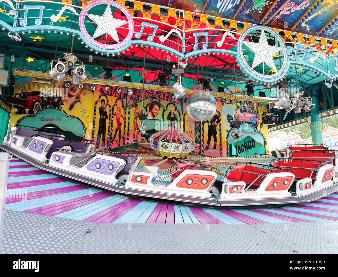 colorful booths and fun rides at a fairground Stock Photo - Alamy