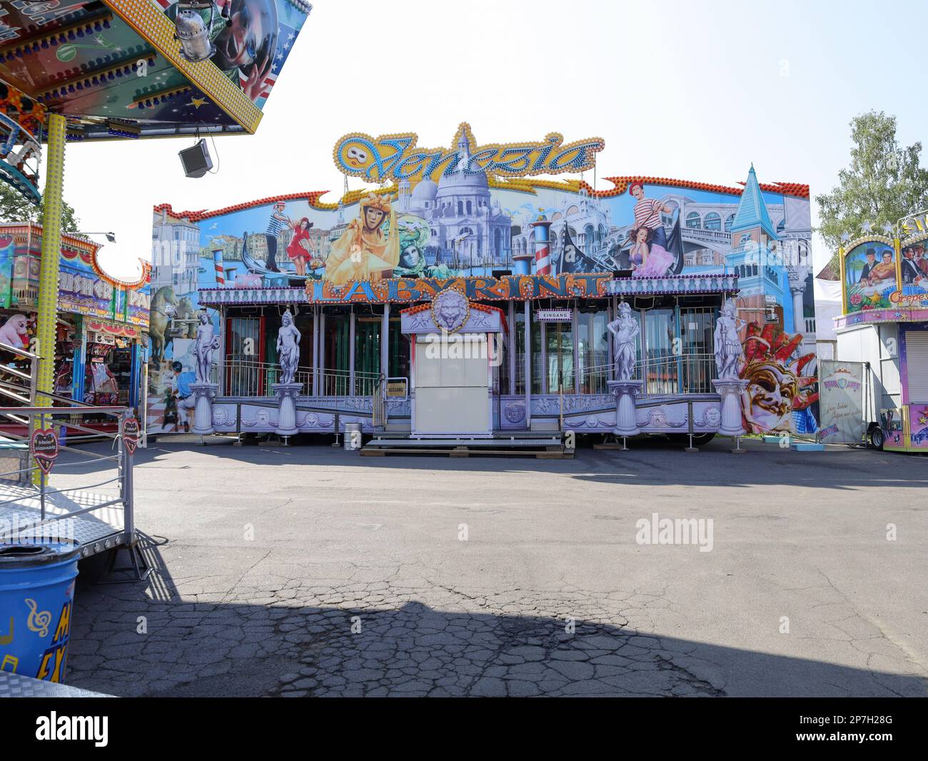 colorful booths and fun rides at a fairground Stock Photo - Alamy
