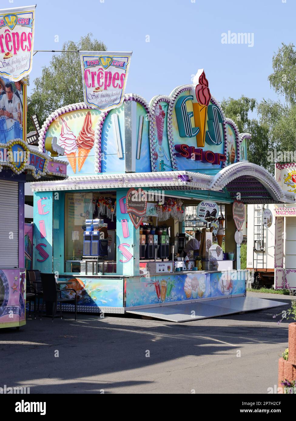 colorful booths and fun rides at a fairground Stock Photo - Alamy
