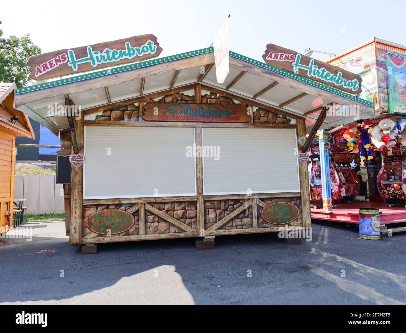 colorful booths and fun rides at a fairground Stock Photo - Alamy