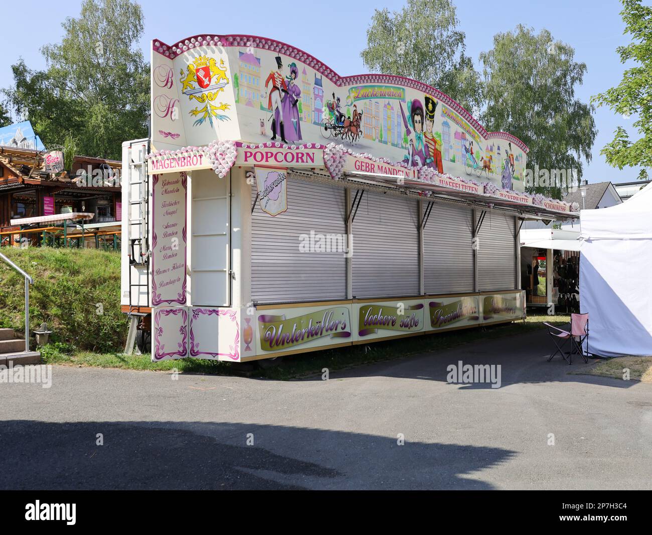 colorful booths and fun rides at a fairground Stock Photo - Alamy