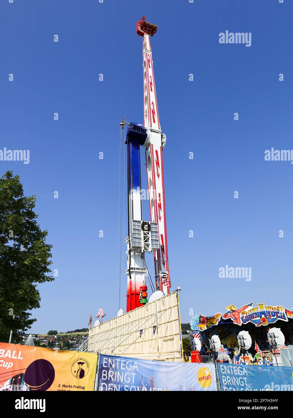 colorful booths and fun rides at a fairground Stock Photo - Alamy