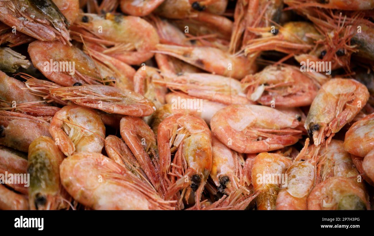 Pink fresh frozen shrimps with ice in a supermarket or fish shop ...
