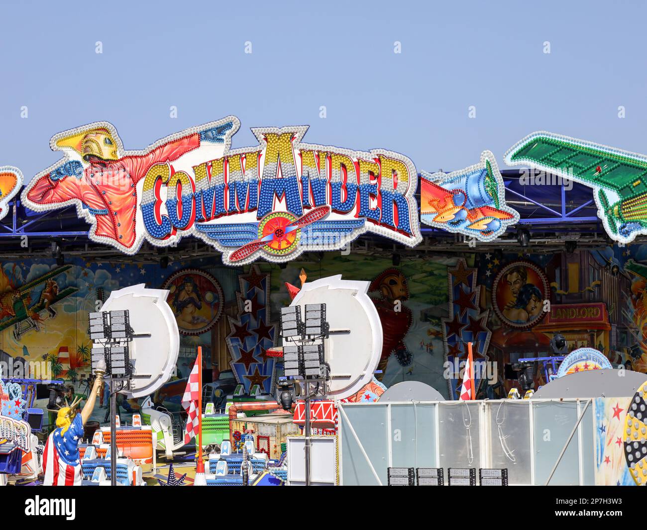 colorful booths and fun rides at a fairground Stock Photo - Alamy