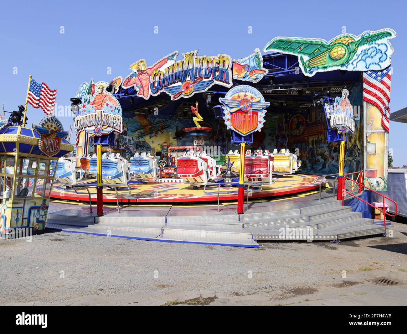 colorful booths and fun rides at a fairground Stock Photo - Alamy
