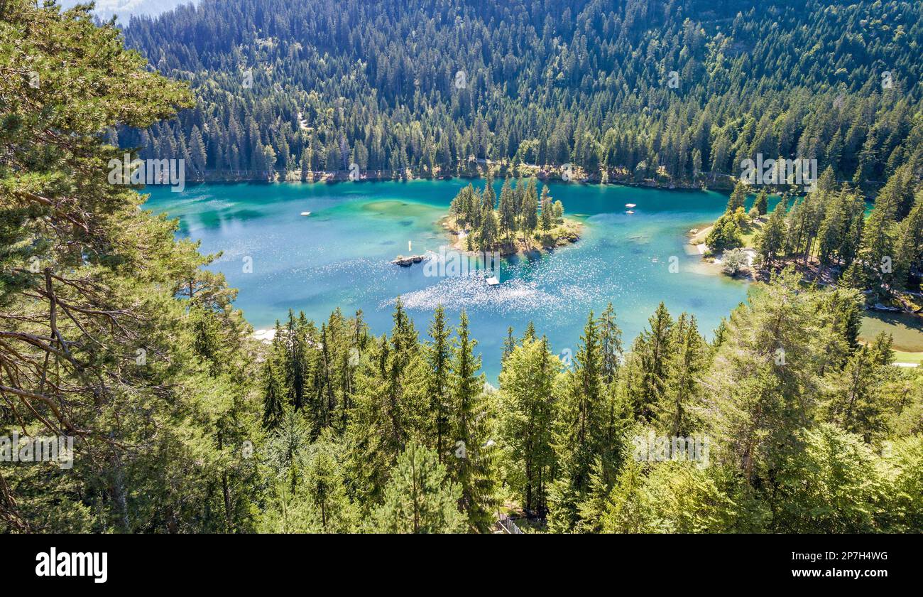 Aerial image of the turquoise Caumasee lake in the alpine mountains in ...
