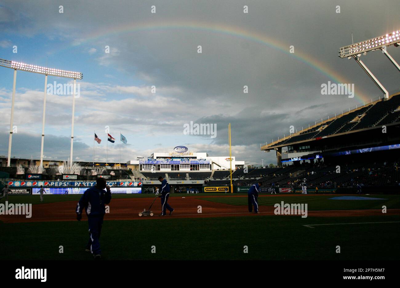 The Kauffman Stadium grounds crew prepares the field under a rainbow ...