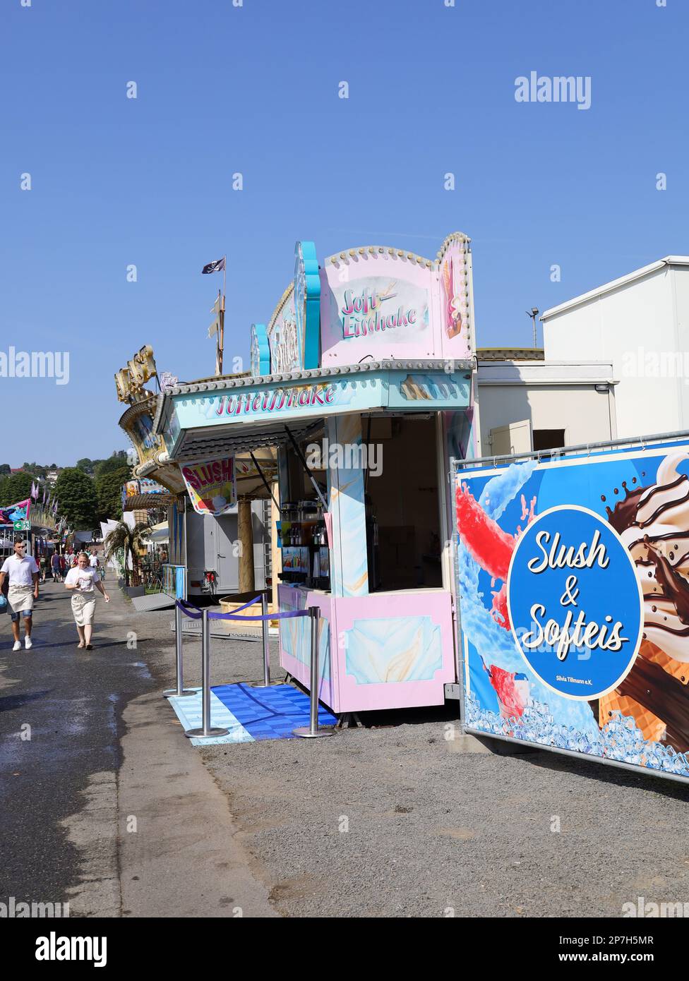 colorful booths and fun rides at a fairground Stock Photo - Alamy