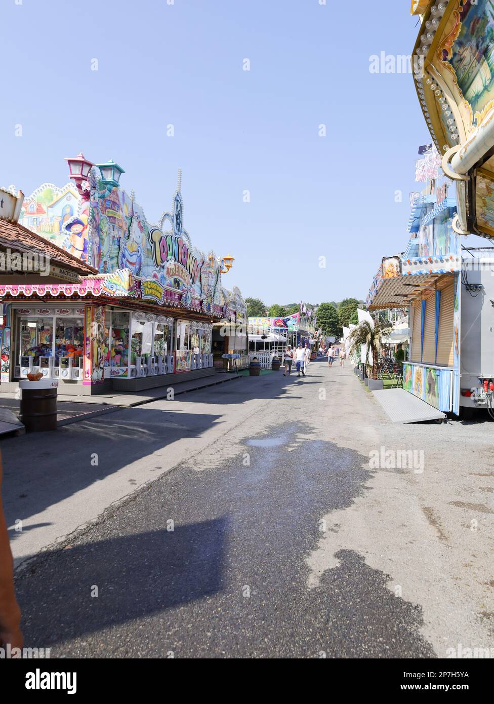 colorful booths and fun rides at a fairground Stock Photo - Alamy