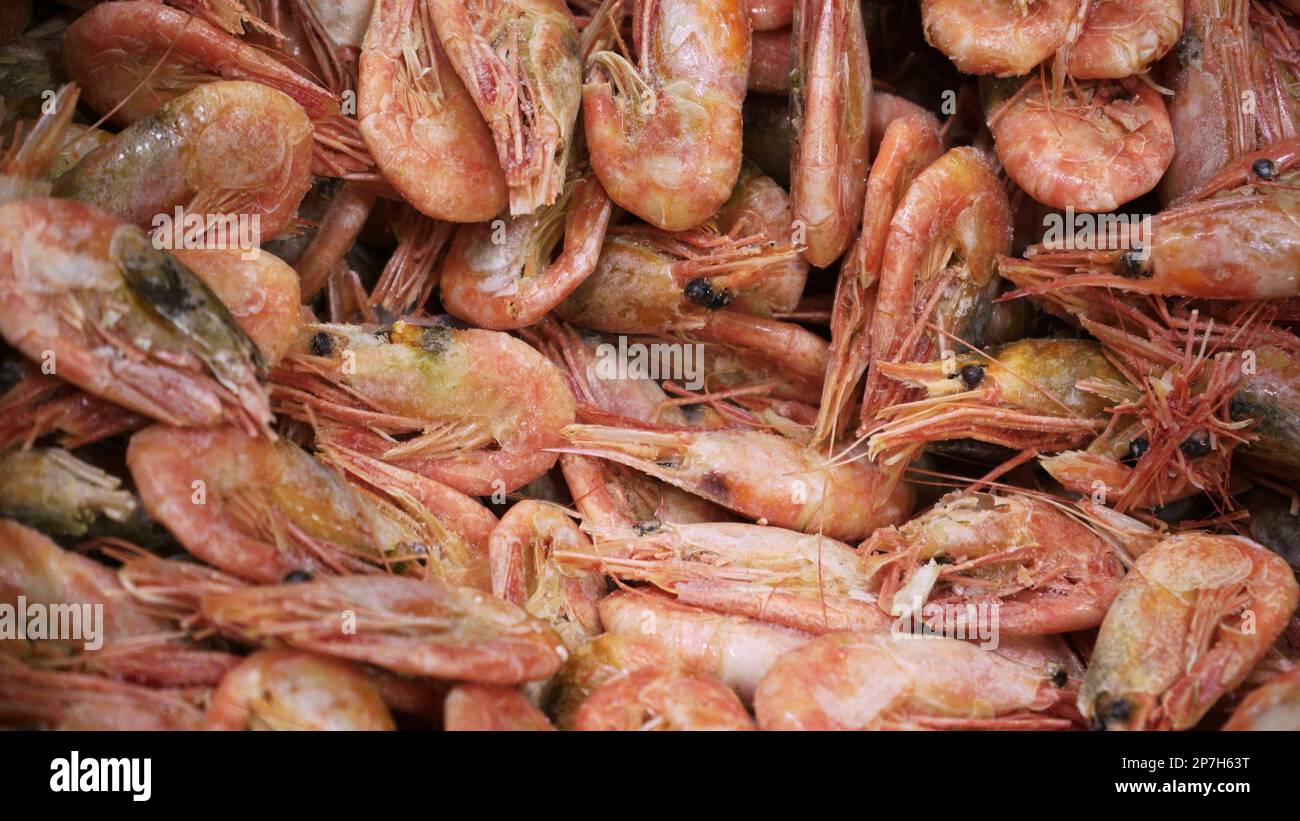 Pink fresh frozen shrimps with ice in a supermarket or fish shop ...