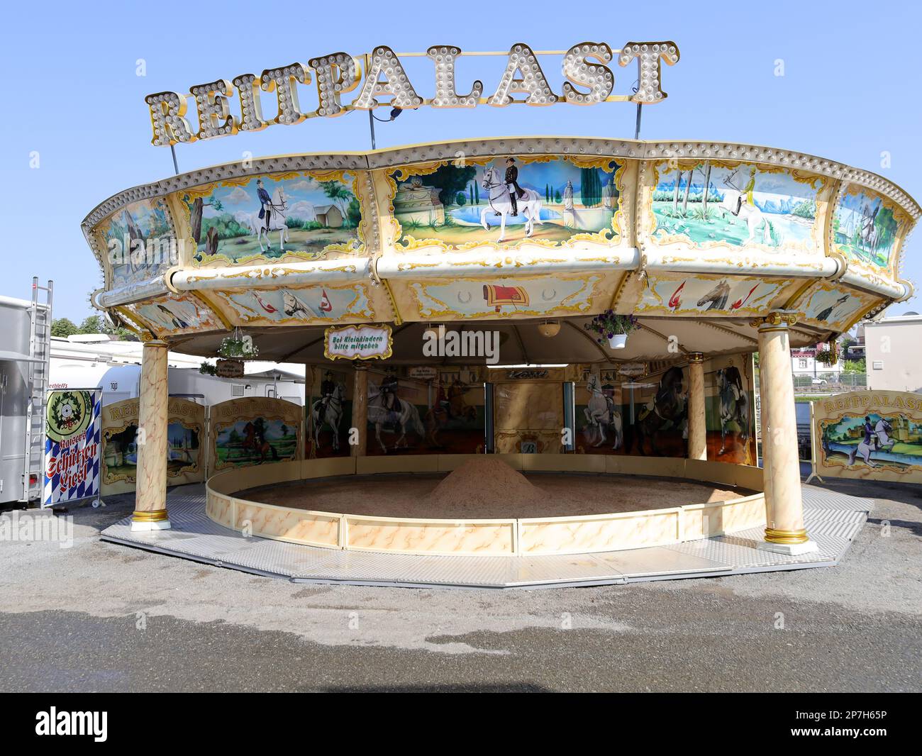 colorful booths and fun rides at a fairground Stock Photo - Alamy