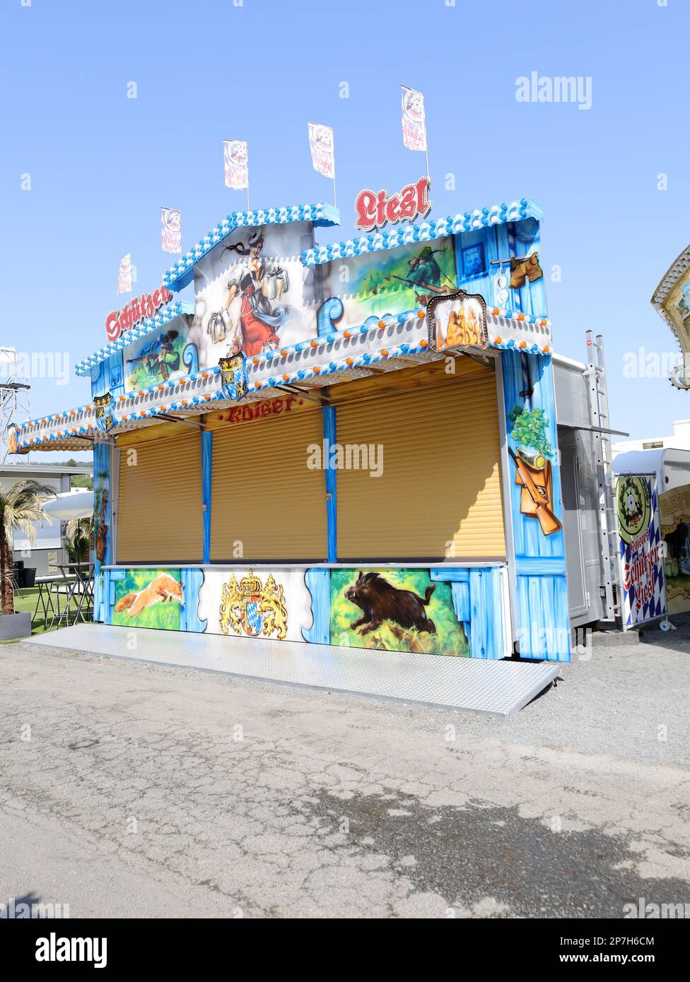 colorful booths and fun rides at a fairground Stock Photo - Alamy