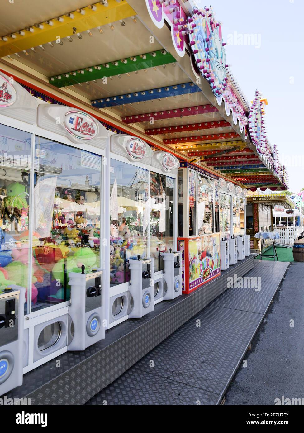 colorful booths and fun rides at a fairground Stock Photo - Alamy