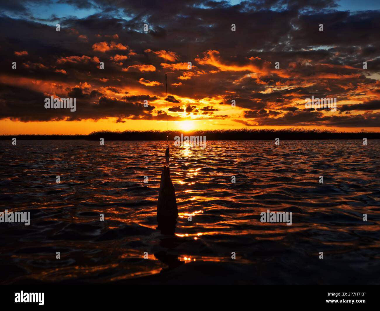 Fishing at sunset. Catching predatory fish on spinning. Sunset colors ...