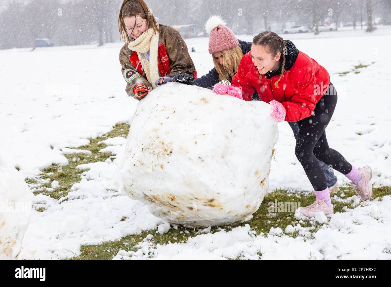 Young women at play in the snow Stock Photo - Alamy