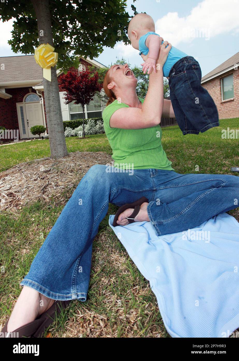 Kami Recla plays with her 5-month-old son Austin, in the front yard at ...