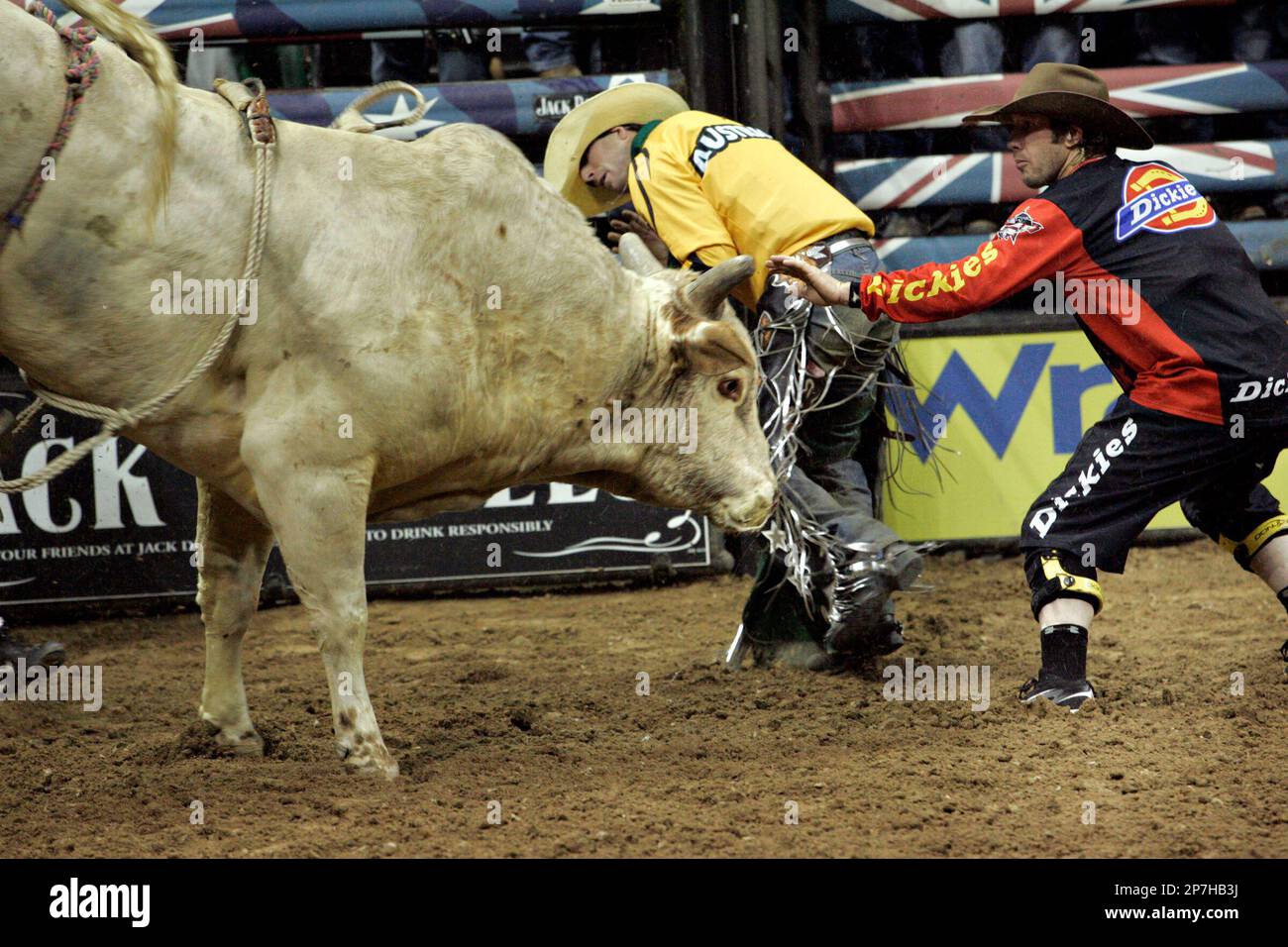 A PBR bull fighter protects an Australian rider during the Pro Bull ...