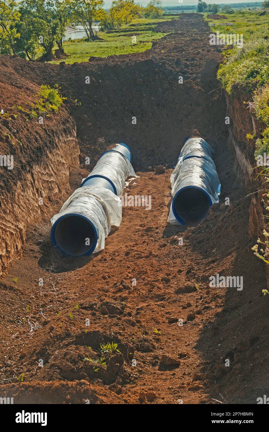 Laying a water pipe (water conduit) underground. Two large diameter ...