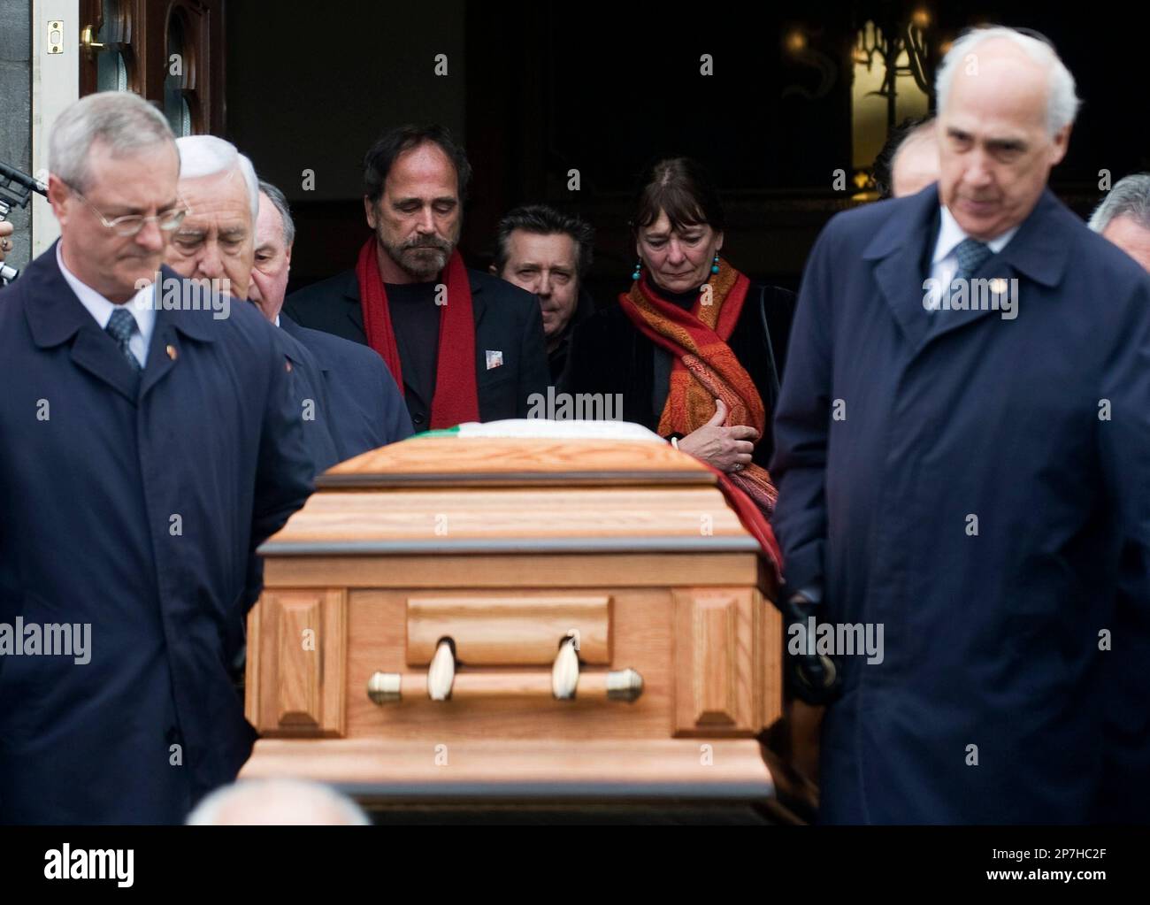 Family members walk behind the coffin of Michel Chartrand following his ...