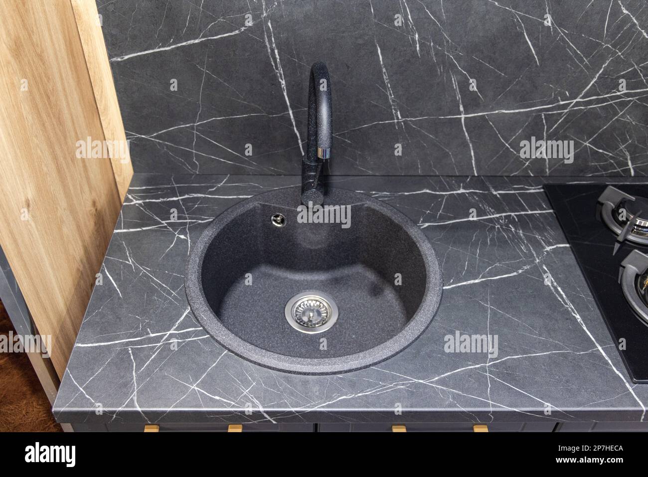 Round Black Kitchen Sink at Marble Style Counter Stock Photo - Alamy