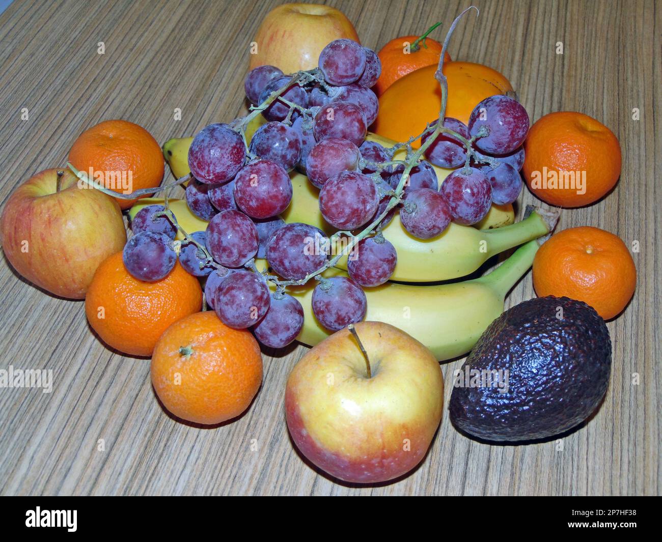 fruits on a wooden background - clementines, persimmon, apples, apple ...