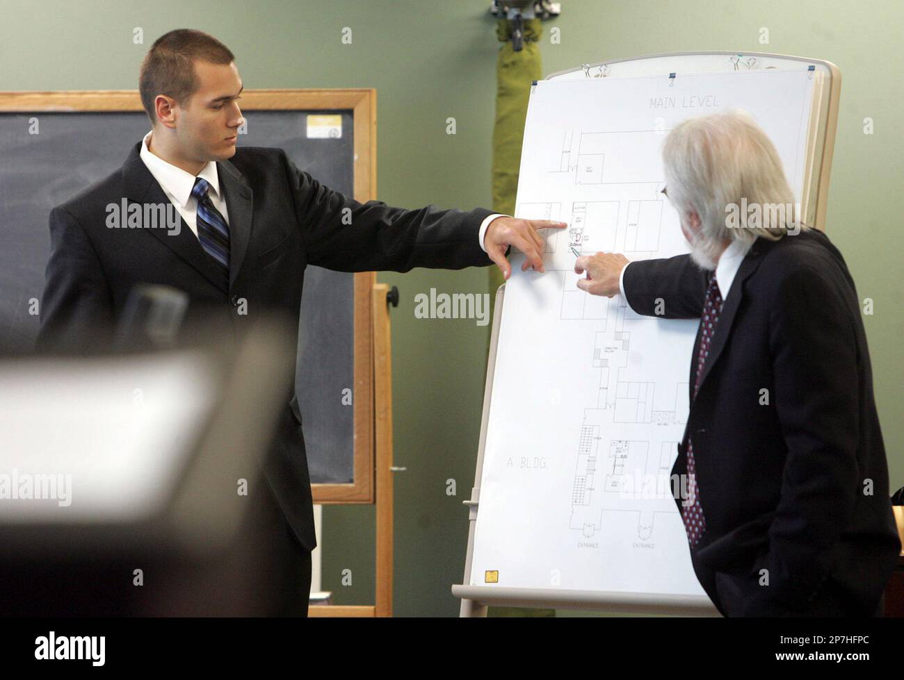 Witness Ryan Kemp, left, points out the area on a diagram to defense ...