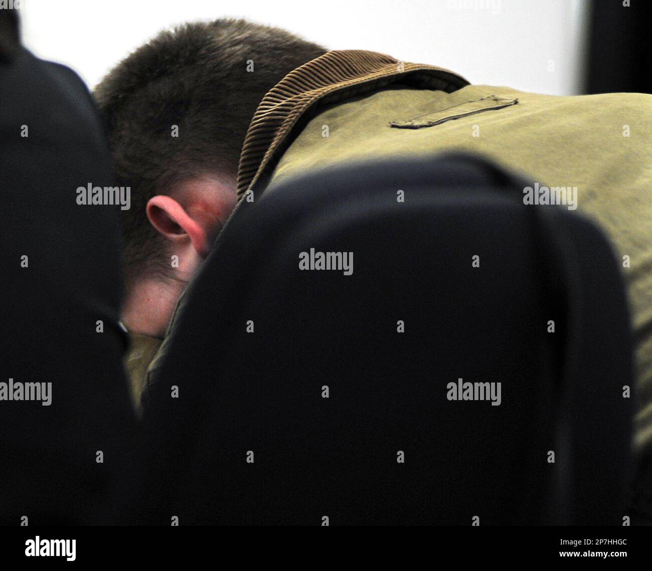 Defendant John Odgren, 19, lays his head down on the desk as Judge Jane ...