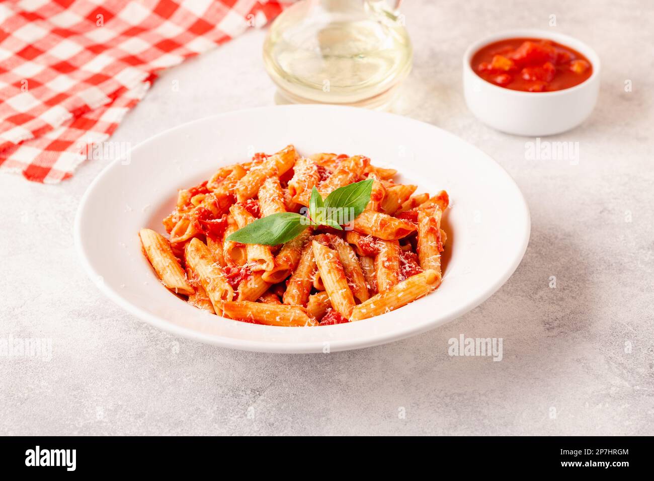 Classic italian pasta penne alla arrabiata with fresh basil on a light ...