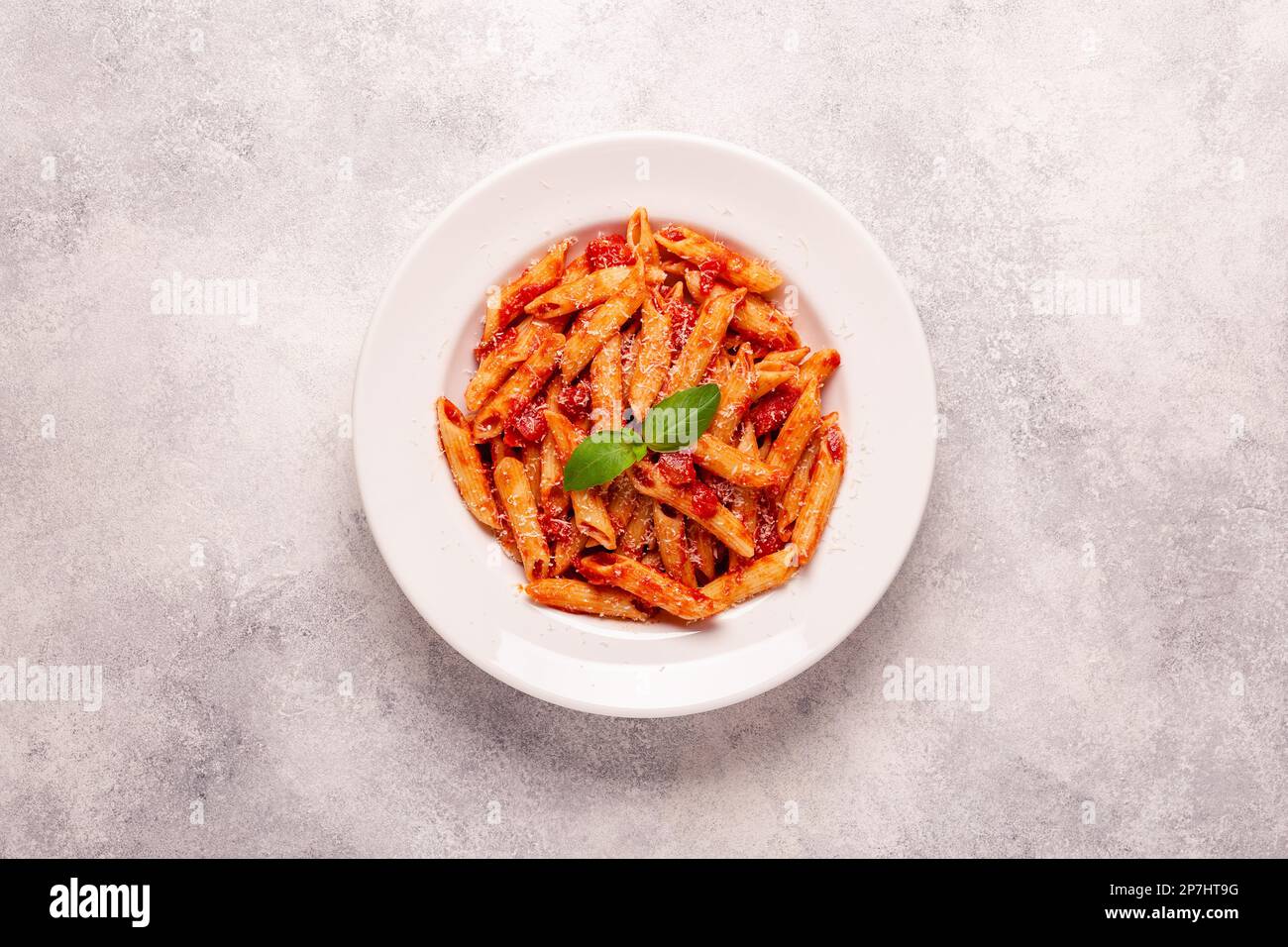 Classic italian pasta penne alla arrabiata with fresh basil on a light ...