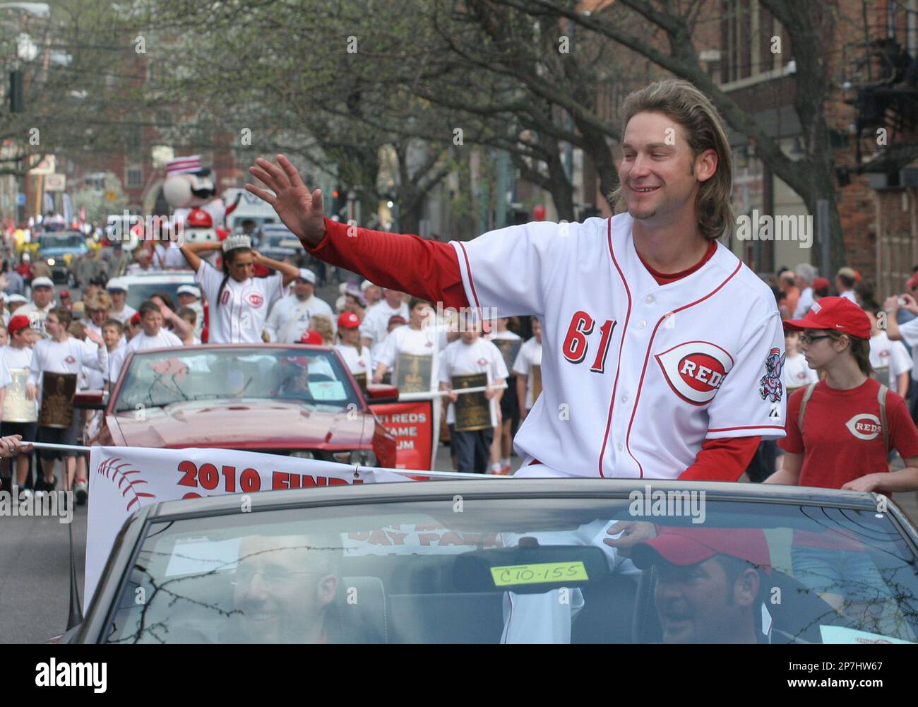 Cincinnati Reds pitcher Bronson Arroyo waves to fans as he rides in a ...