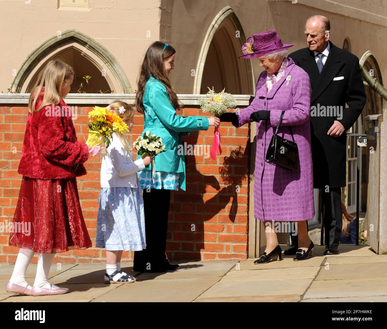 Britain's Queen Elizabeth II is presented with flowers by 10-year-old ...