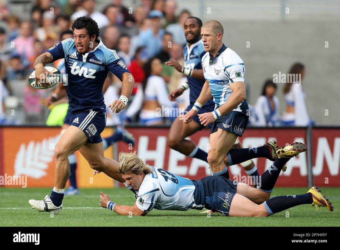 Blues' Rene Ranger slips the tackle of Bulls' Wynand Olivier in a Super ...