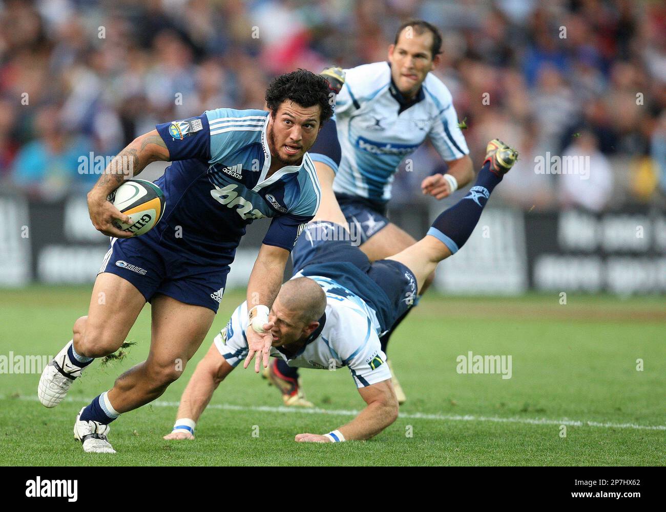 Blues' Rene Ranger slips the tackle of Bulls' Jaco Pretorius in a Super ...