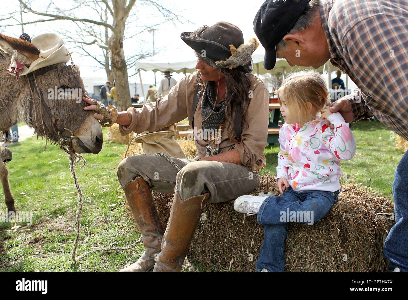 Kasey Perry, 3, and her grandfather Paul Garrison, right, talk with ...