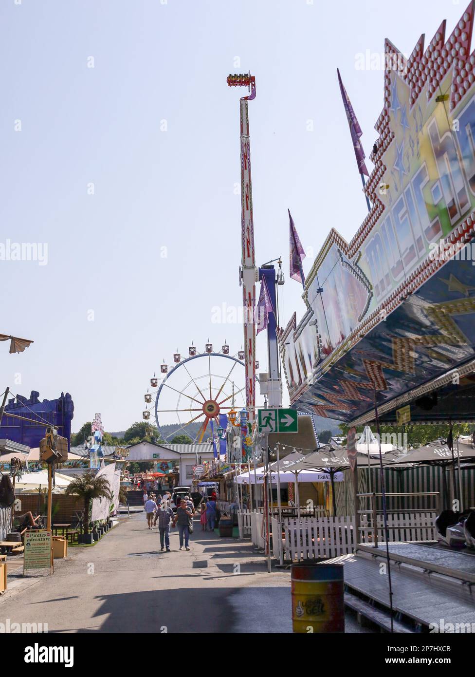 colorful booths and fun rides at a fairground Stock Photo - Alamy